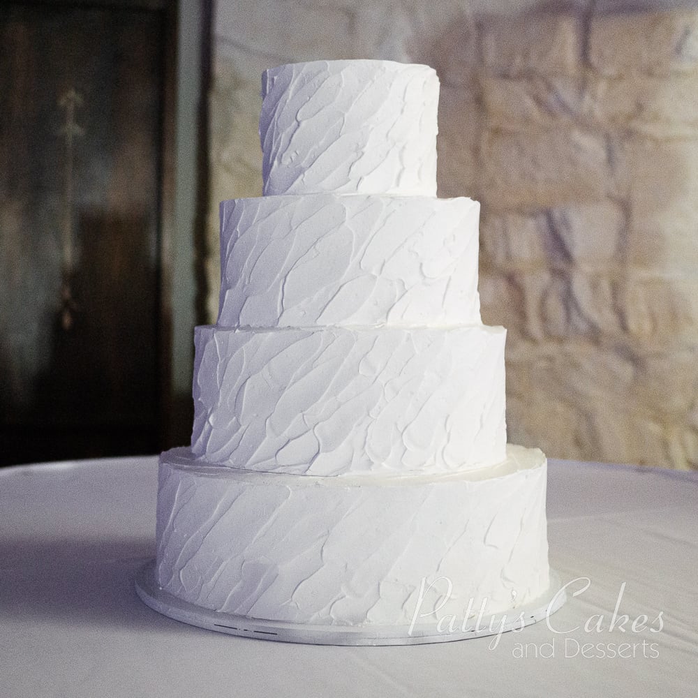 Photo of a angle texture white 4 tier cake - Patty's Cakes and Desserts